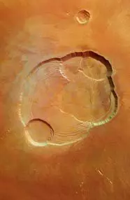 Olympus Mons чокусу жогоруда сүрөттөлгөн. Бул биздин Күн системасындагы эң чоң тоо. Бул Эвересттен үч эсе жогору болгон өчкөн вулкан. Бул сүрөттөгү депрессиялар деп аталат