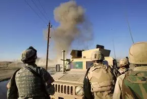 Anggota tim bom Angkatan Darat AS lalajo peledakan anu dikontrol tina alat peledak improvisasi (IED) pikeun ngabersihan jalan-jalan di Baghdad, Irak.